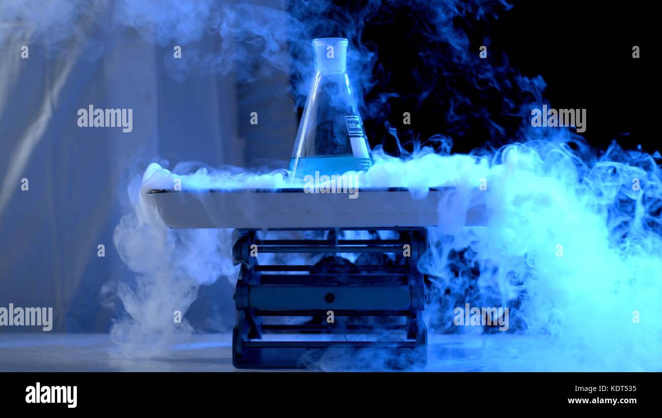 Bottle and liquid nitrogen in a laboratory. Chemical experiment. Flask ...