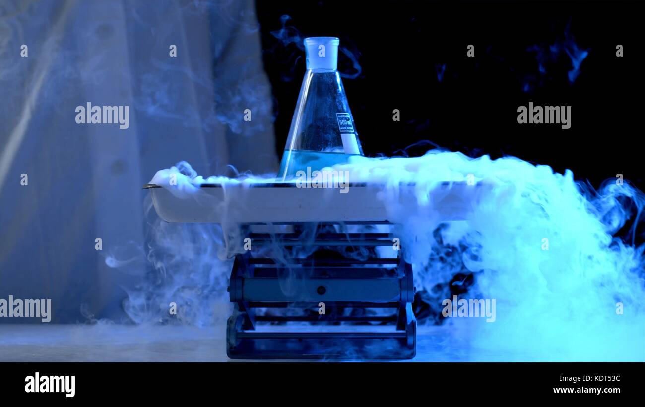Bottle and liquid nitrogen in a laboratory. Chemical experiment. Flask ...