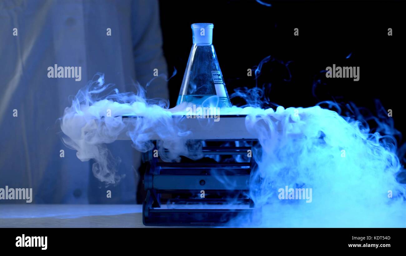 Bottle and liquid nitrogen in a laboratory. Chemical experiment. Flask ...