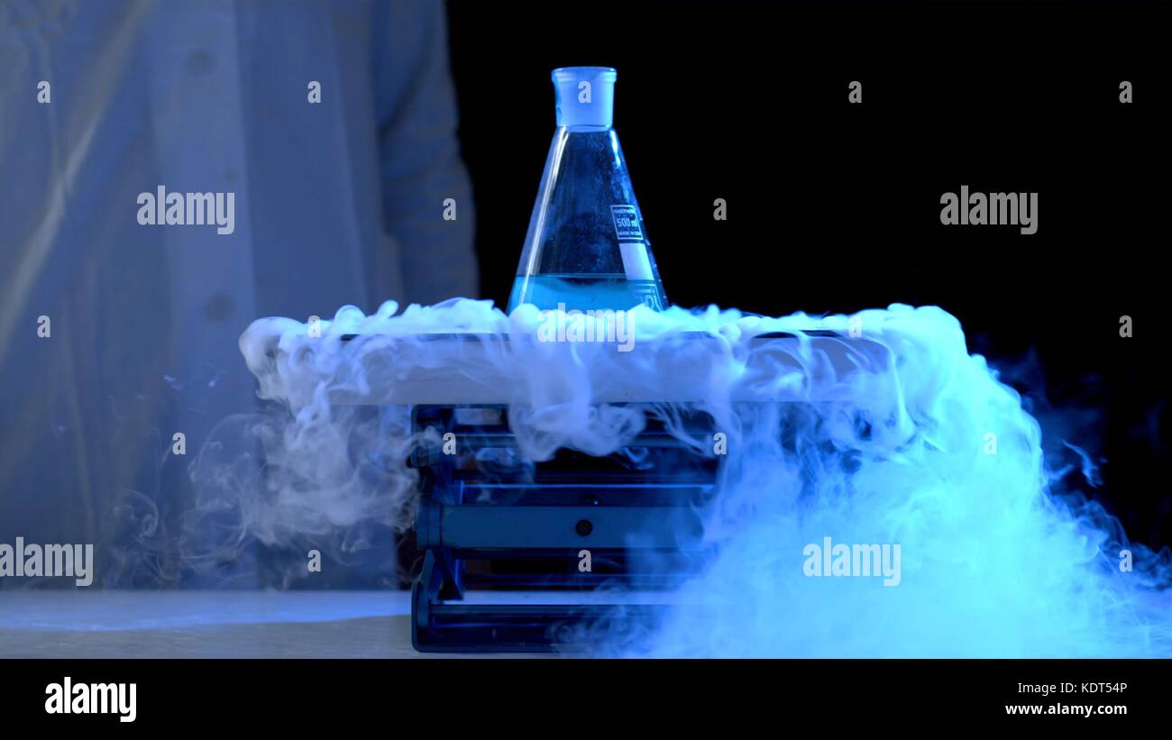 Bottle and liquid nitrogen in a laboratory. Chemical experiment. Flask ...