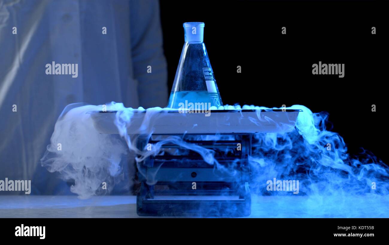 Bottle and liquid nitrogen in a laboratory. Chemical experiment. Flask ...