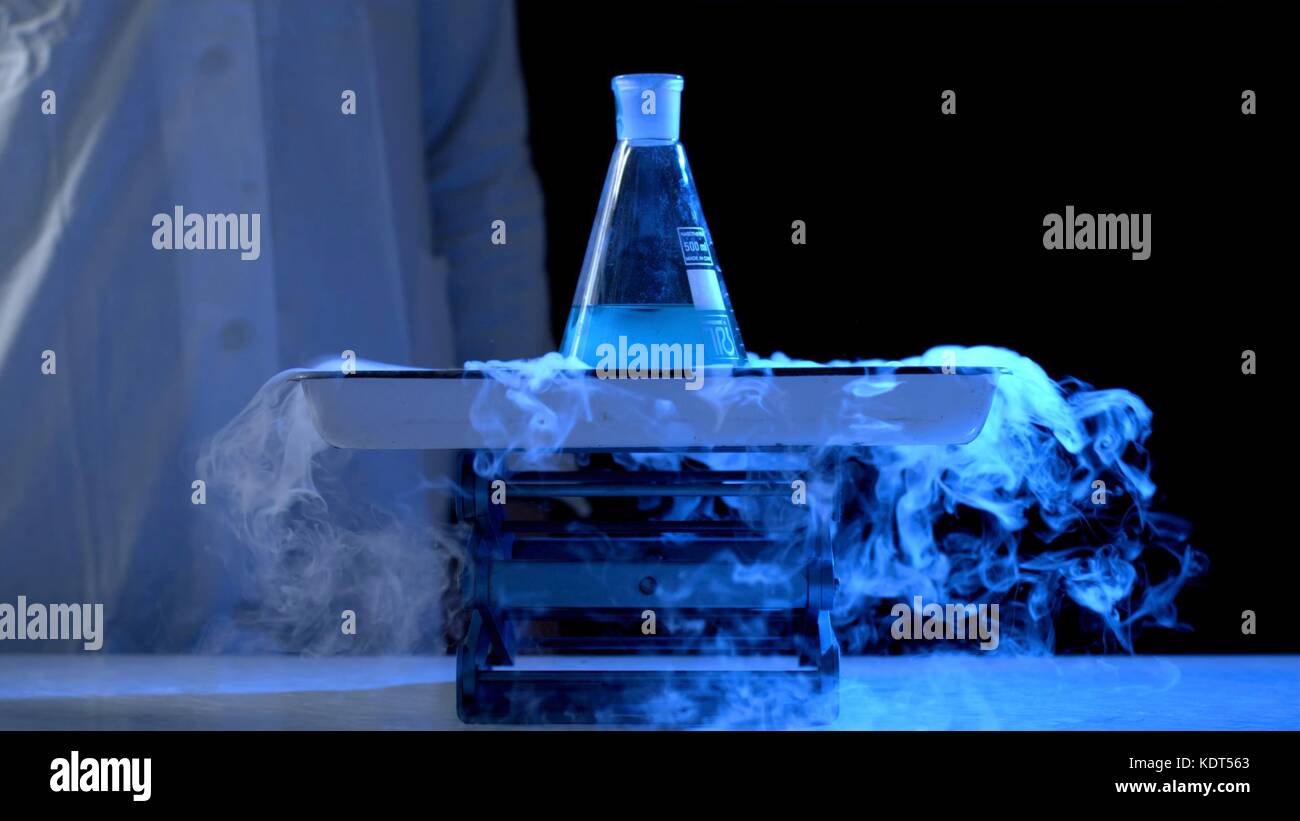 Bottle and liquid nitrogen in a laboratory. Chemical experiment. Flask ...