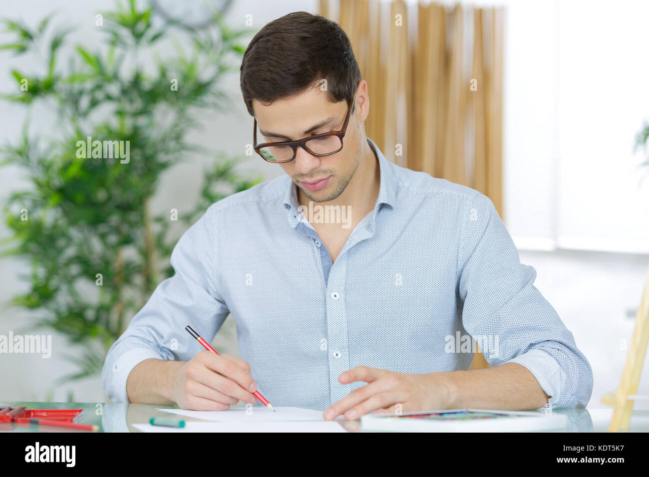graphic designer sitting with color fans and pencil Stock Photo - Alamy