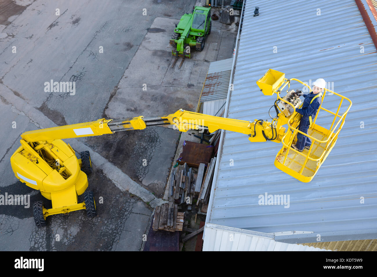 Looking down on woman in cherry picker Stock Photo - Alamy
