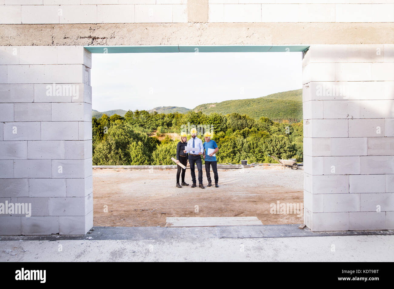 Architect, civil engineer and worker looking at plans and blueprints ...
