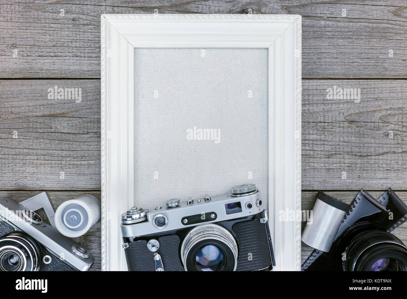 antique cameras, negative films and white empty photo frame on grunge ...
