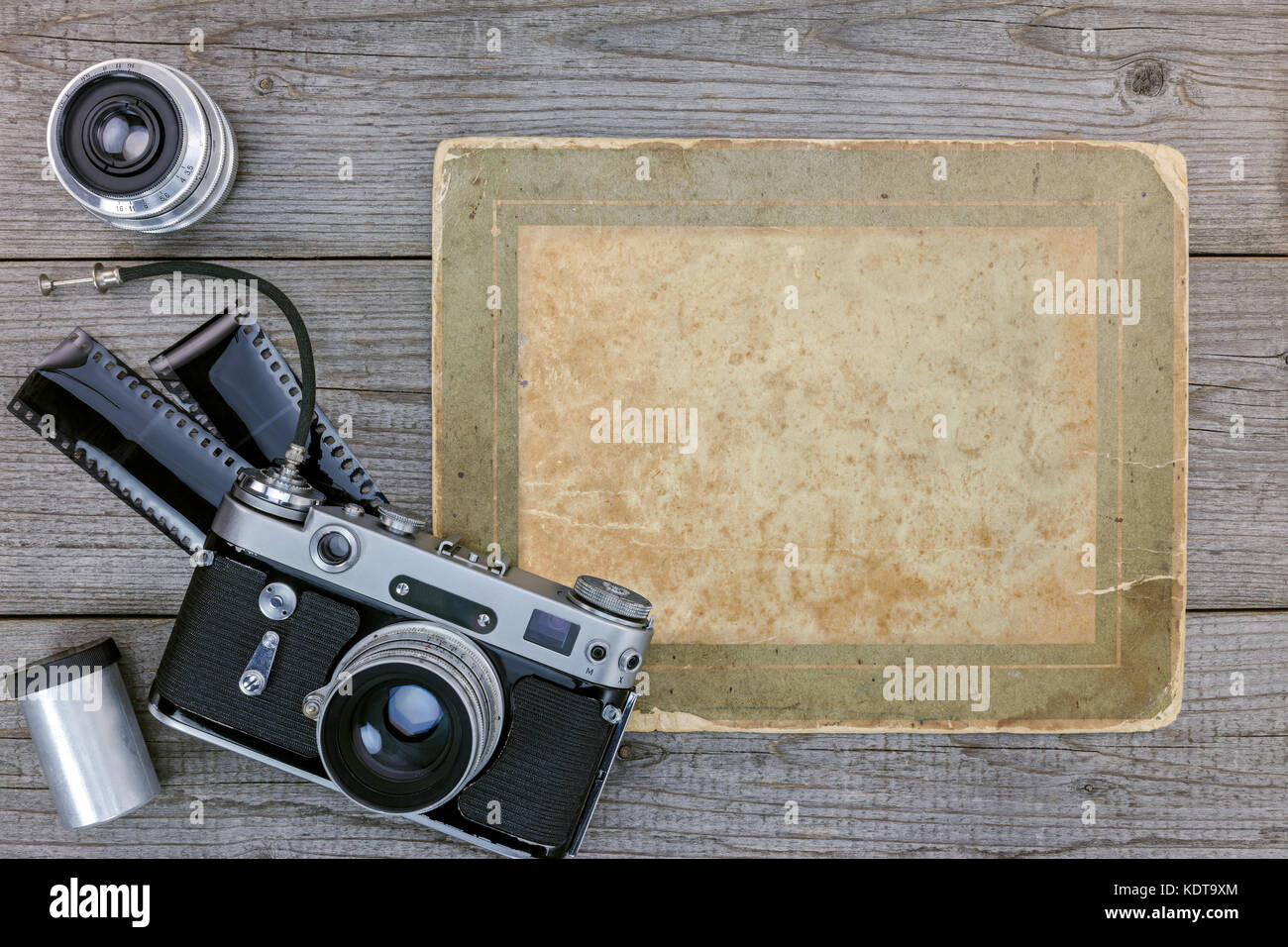 retro camera, negative film, lenses on wooden table background with ...