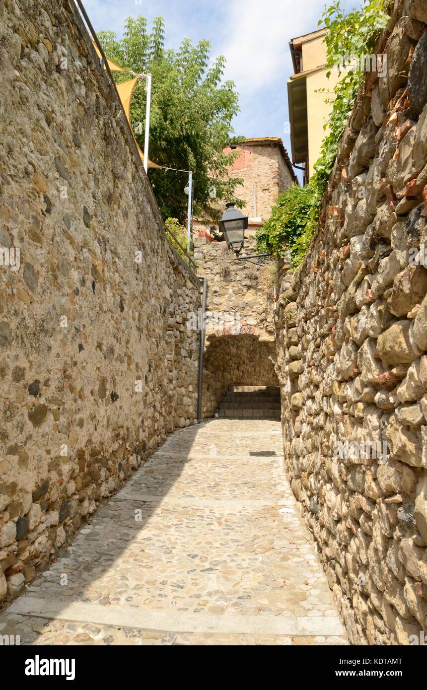 Stairs under stone arch in alley of Besalu, a medieval town of Girona ...