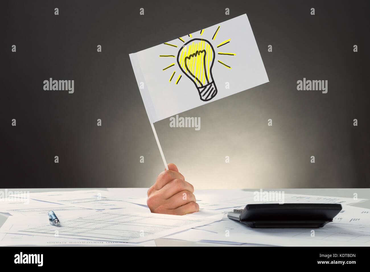 Hand Holding Vision Flag With Bright Idea At Office Desk Filled With ...