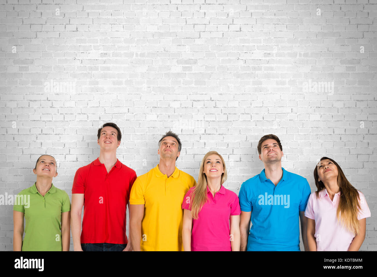 Group of people standing against wall hi-res stock photography and ...