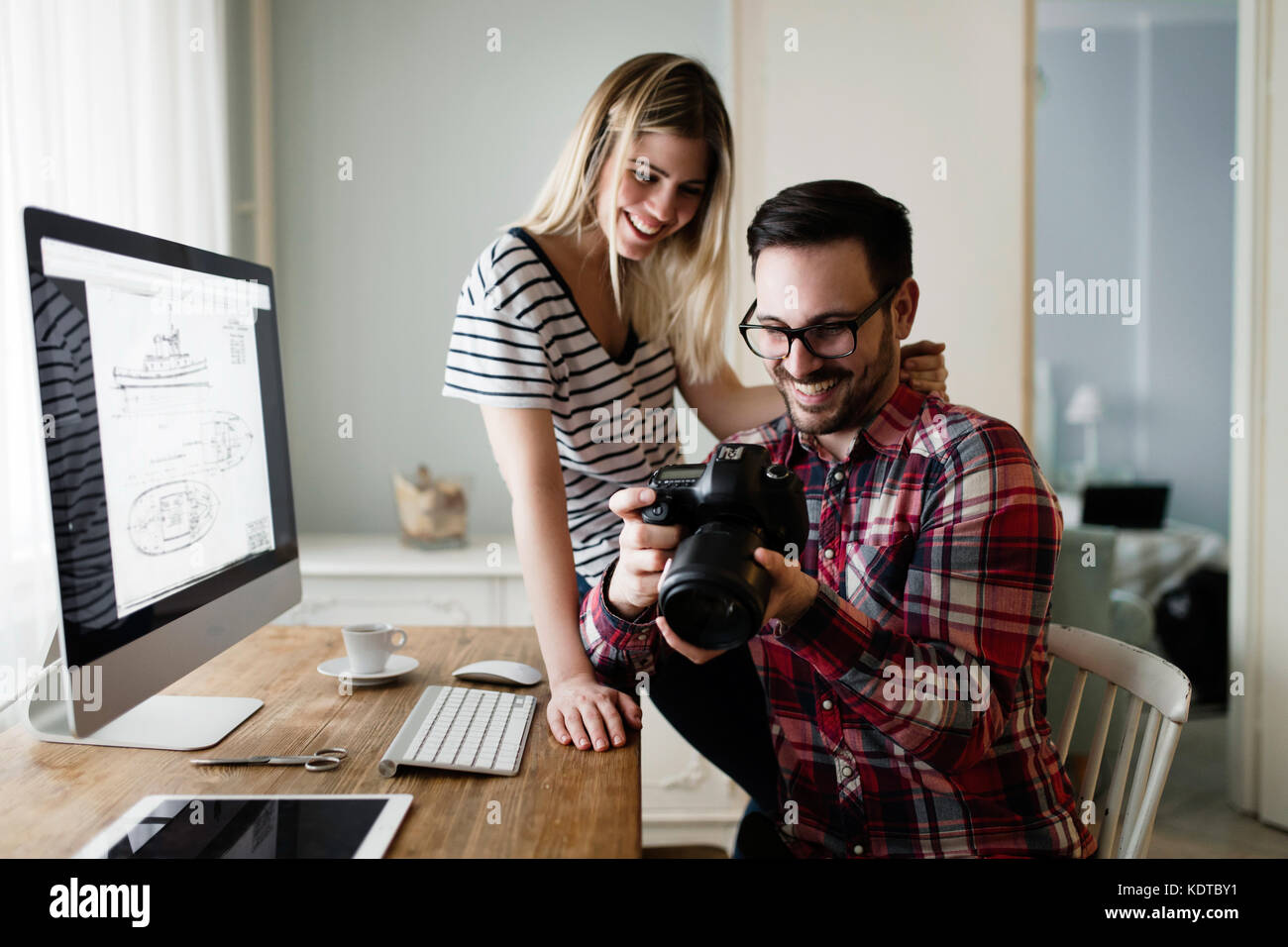 Beautiful woman and attractive man doing design work Stock Photo - Alamy