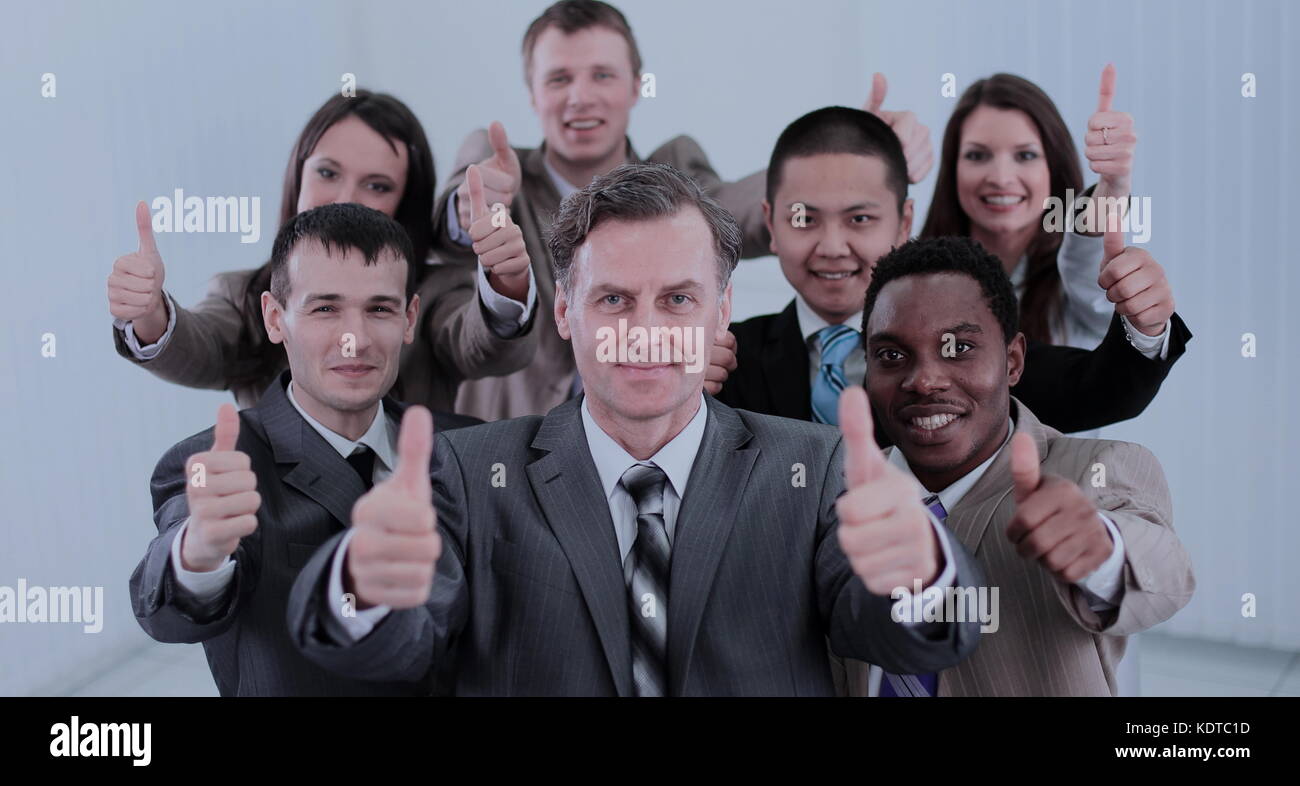 Happy colleagues showing thumbs up in their office Stock Photo - Alamy