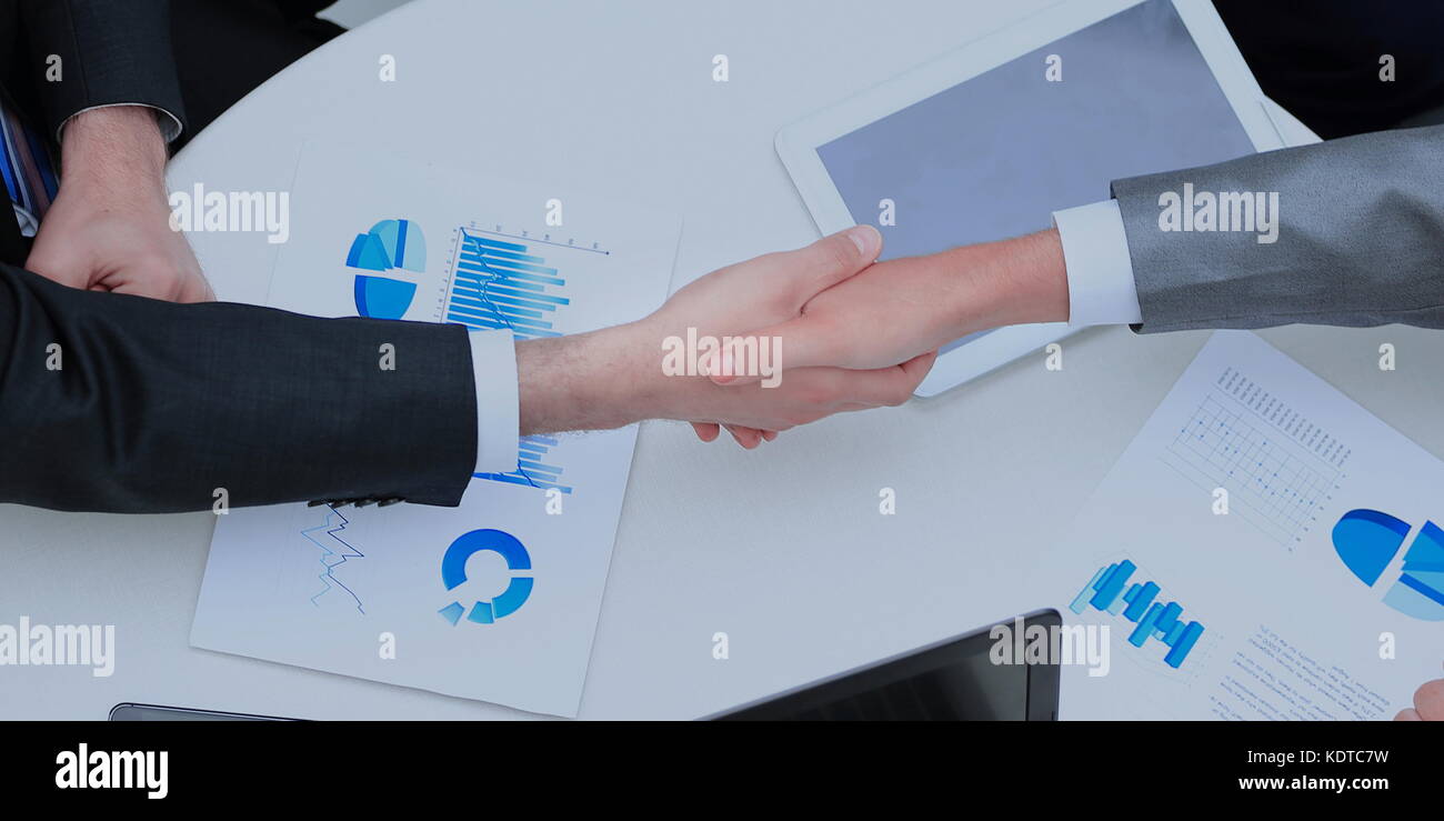 Businessmen shaking hands. Top View Stock Photo - Alamy