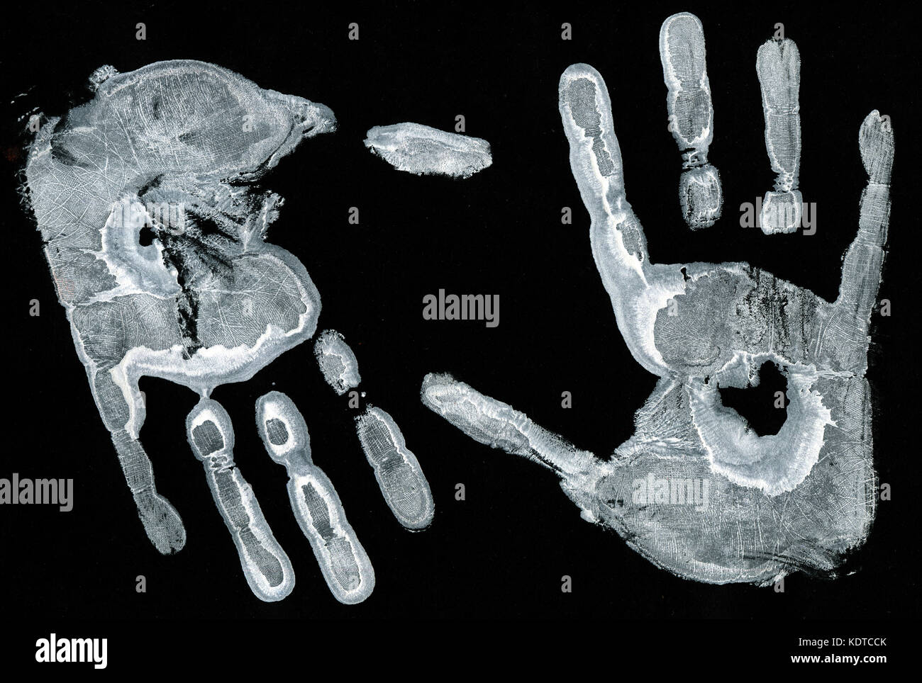 Close up of white hand prints on black background Stock Photo - Alamy