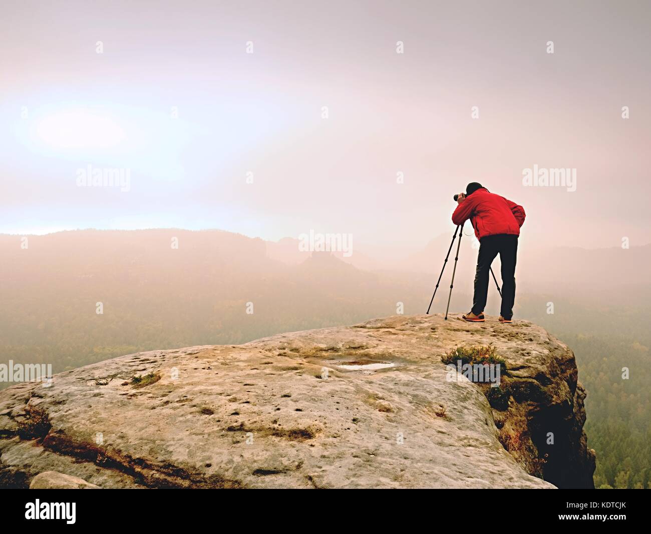 Professional photographer work on mountain peak. Nature photographer ...
