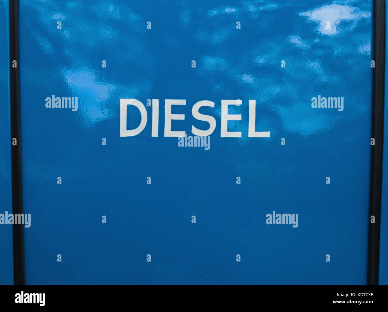 White painted diesel sign on blue background Stock Photo - Alamy