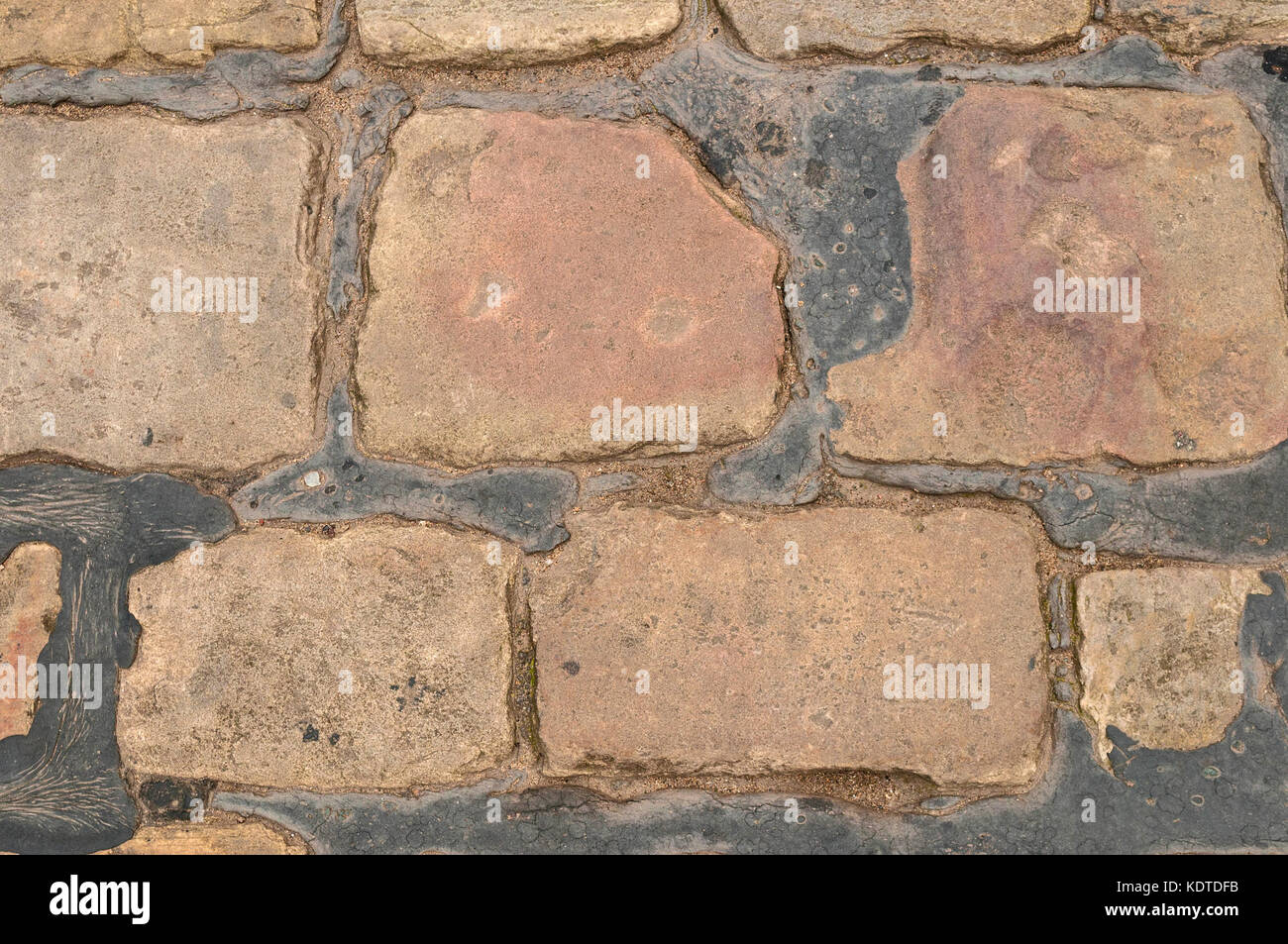Cobble Background set in Tar Stock Photo - Alamy