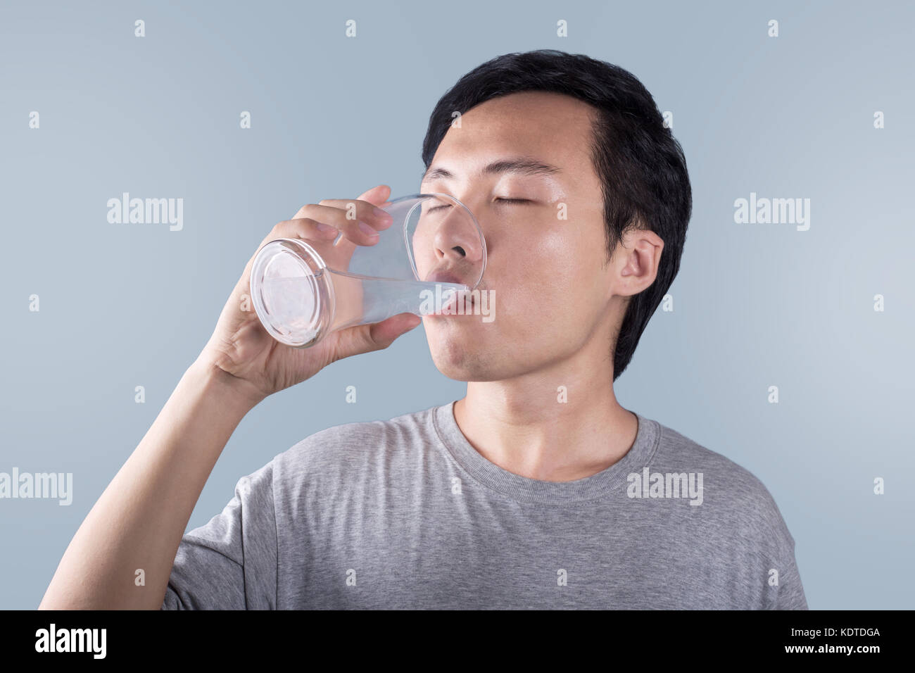 Asian man drinking water Stock Photo - Alamy