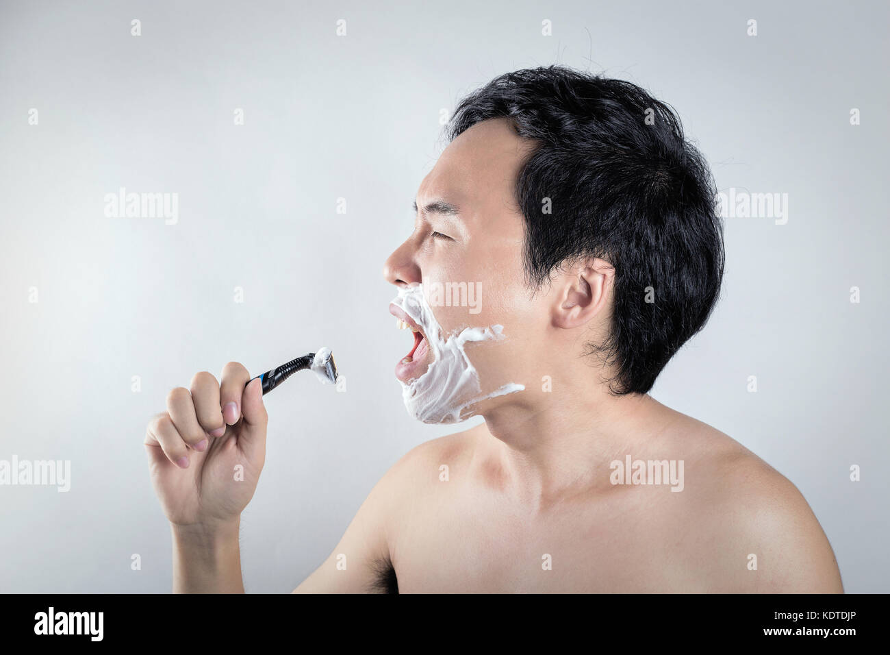 Asian man is shaving Stock Photo - Alamy