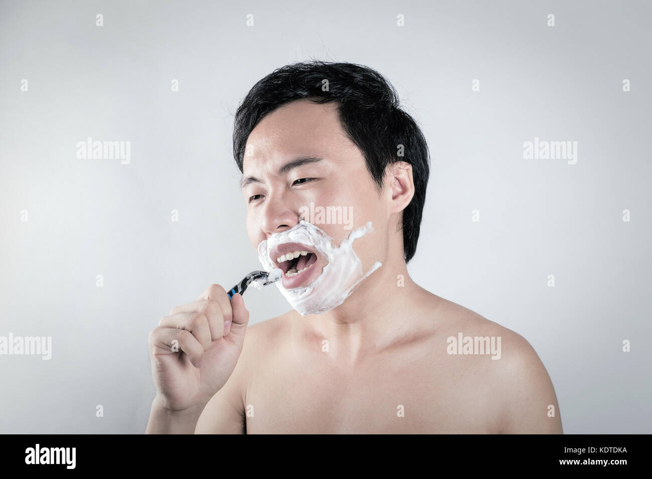 Asian man is shaving Stock Photo - Alamy