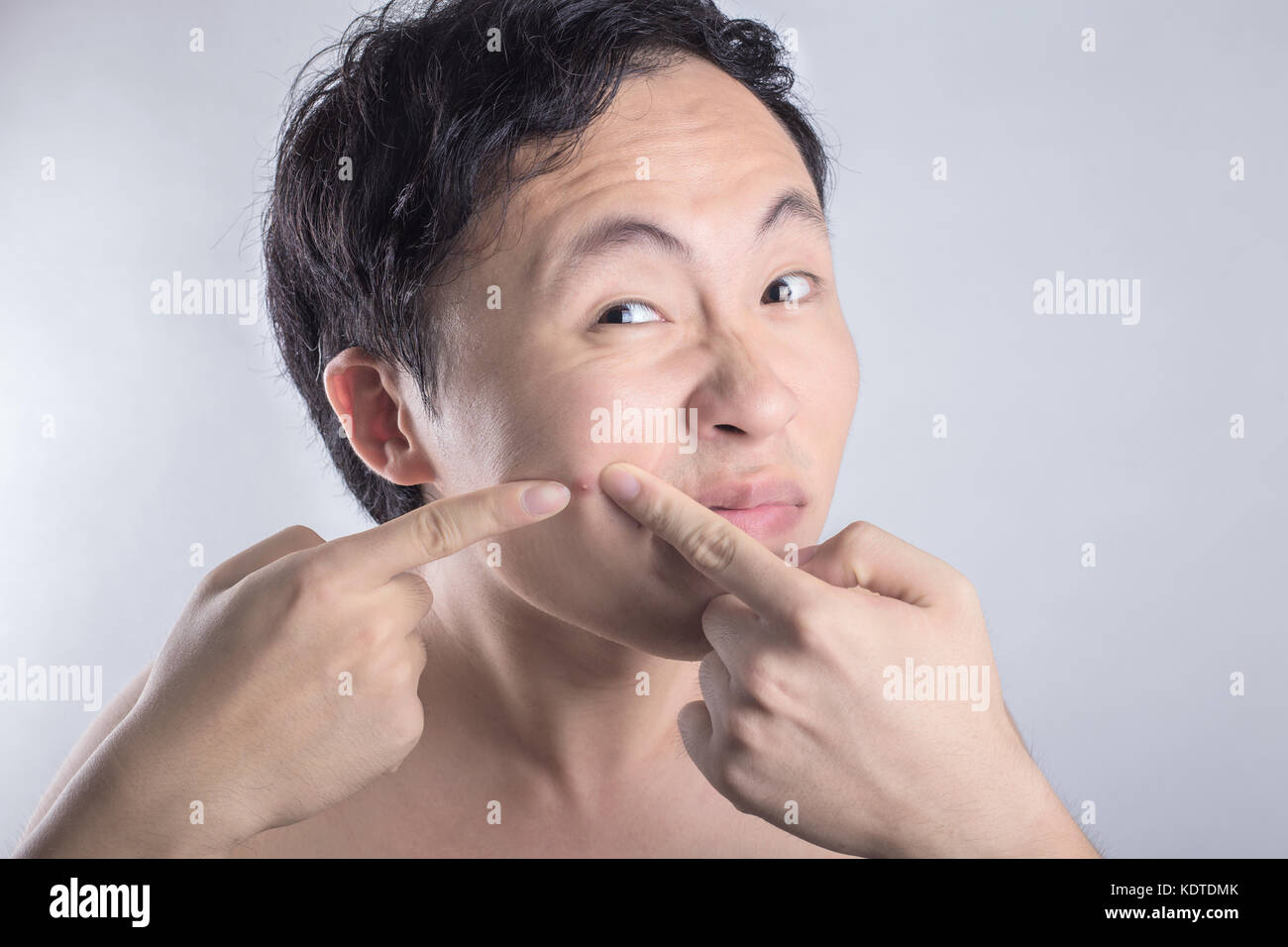 Asian man cleaning face Stock Photo - Alamy