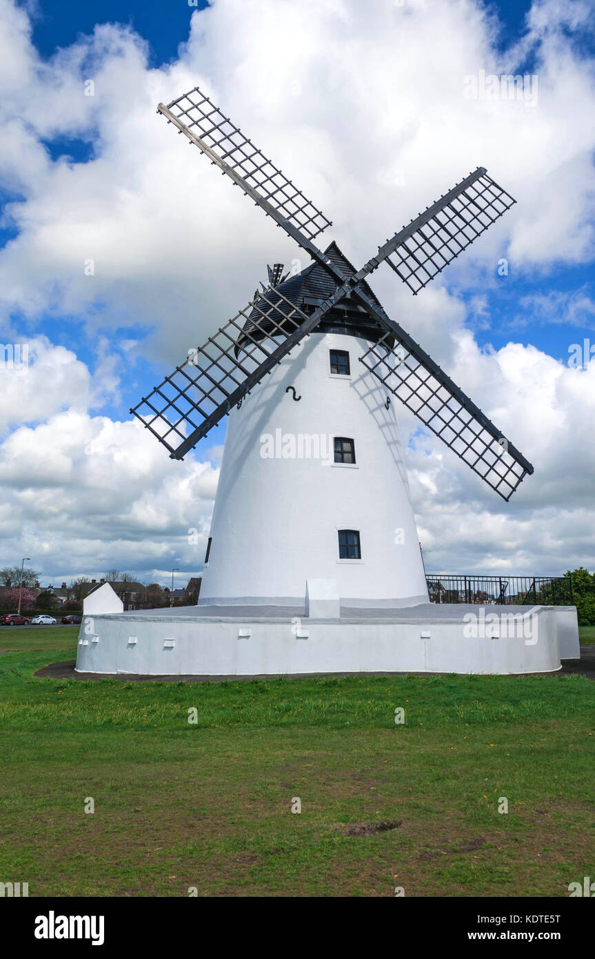 Windmill, with black sails ,wooden slatted roof against blue sky with ...