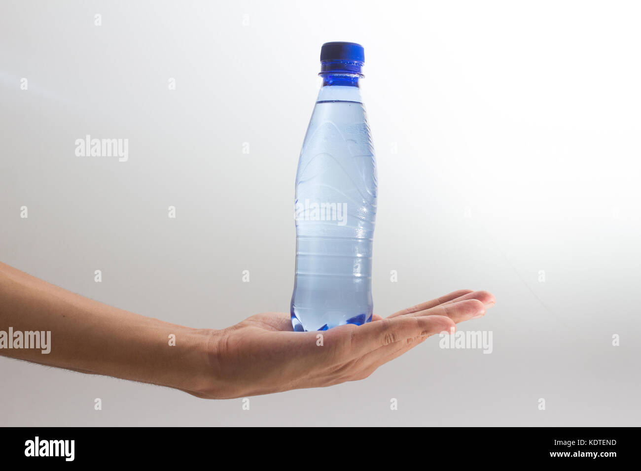hand with bottle of water isolated on white background Stock Photo - Alamy