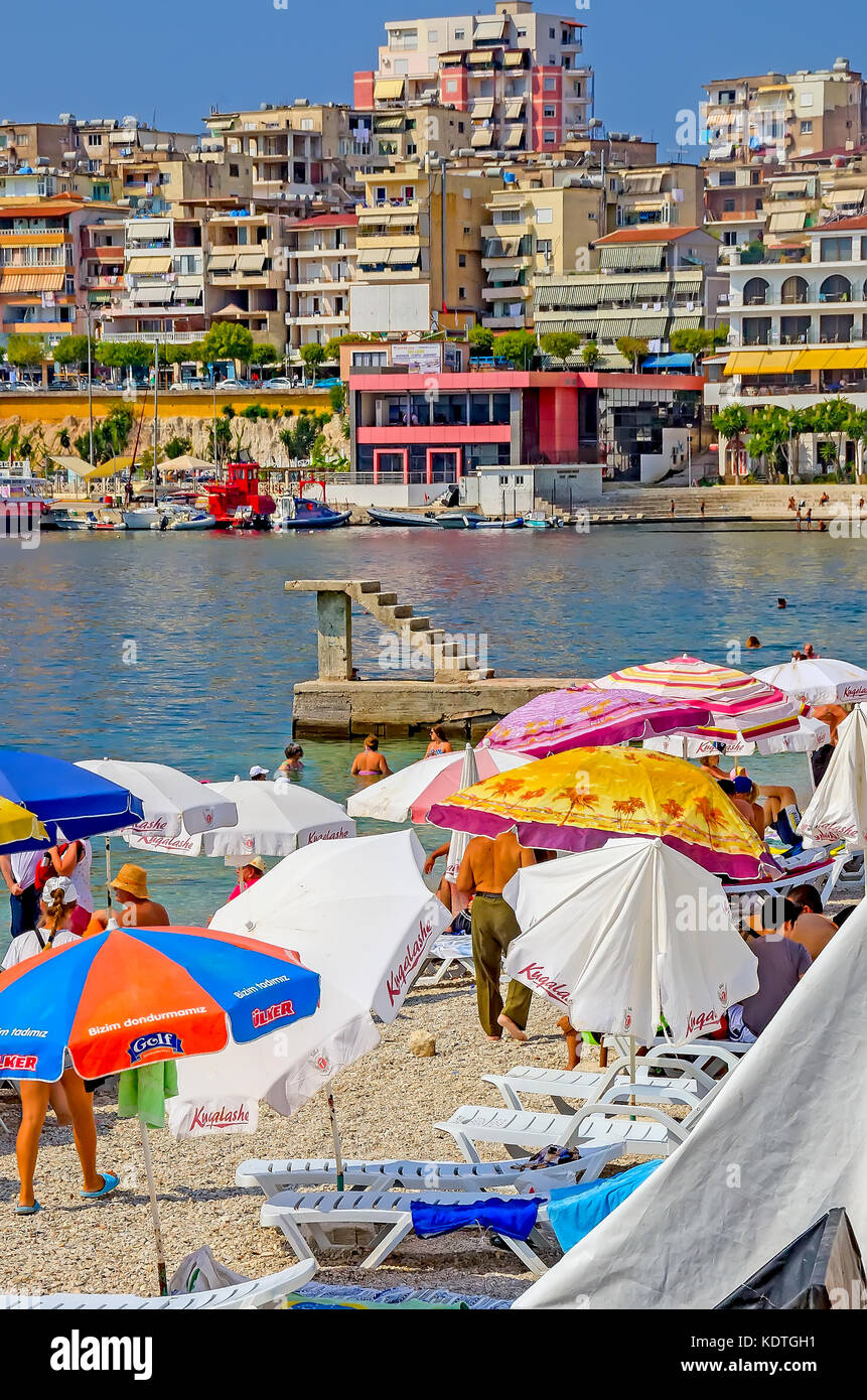 Saranda Albania beach with white umbrellas and city skyline, Sarande ...