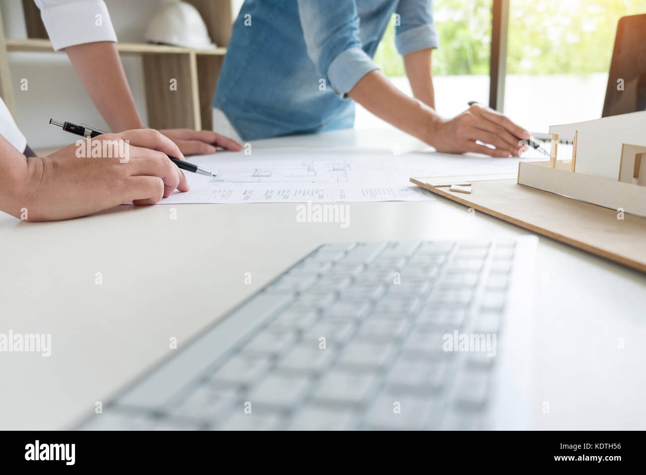 Architects engineer discussing at the table with blueprint - Closeup on ...
