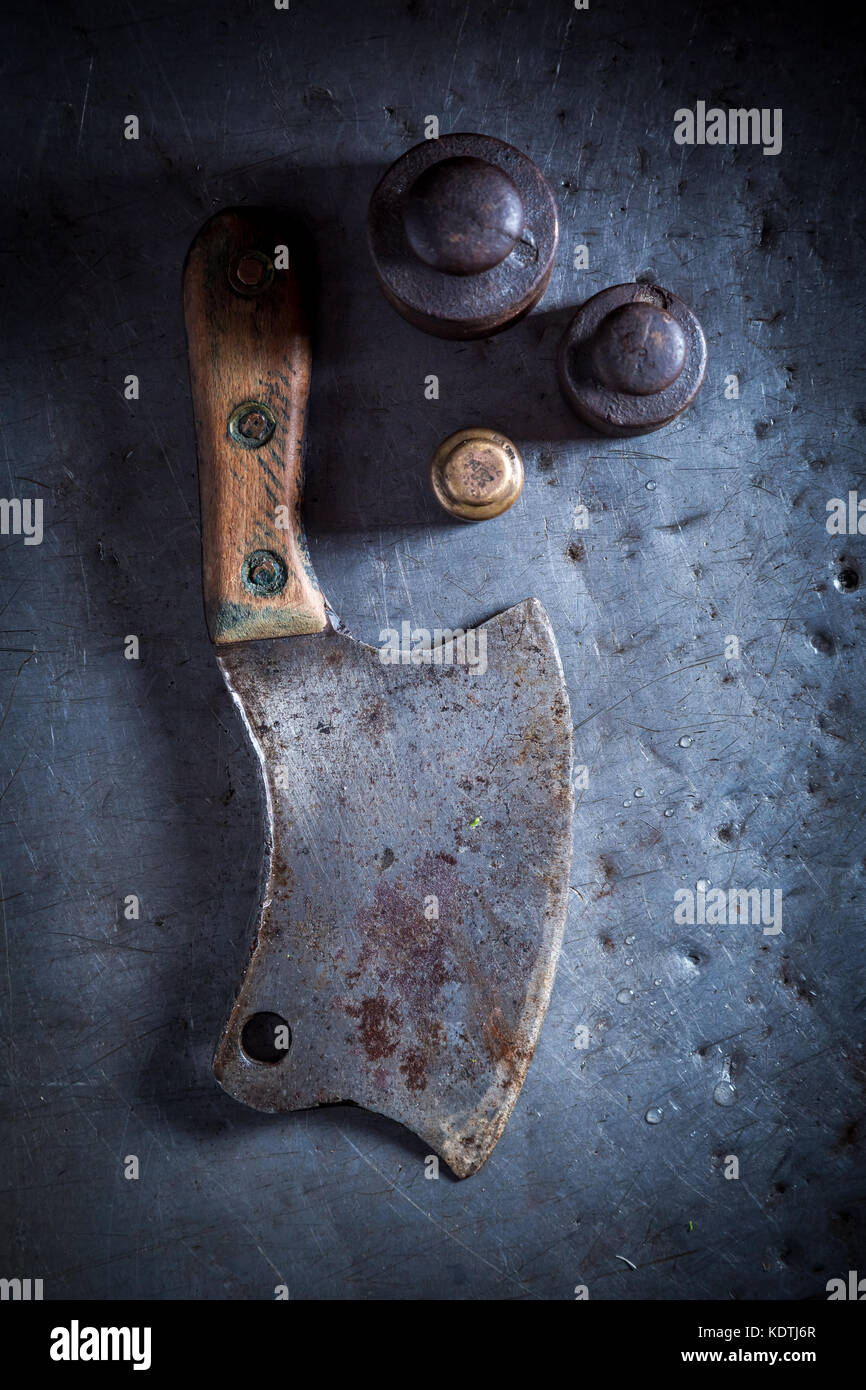 Metal chopper on old metal table with weights Stock Photo - Alamy