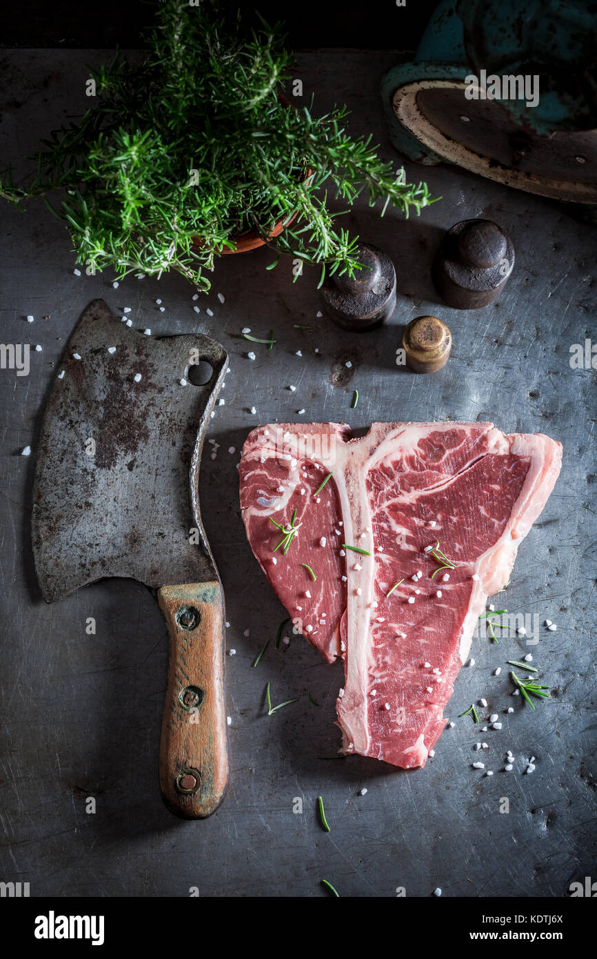 Bloody red steak on old metal table Stock Photo - Alamy