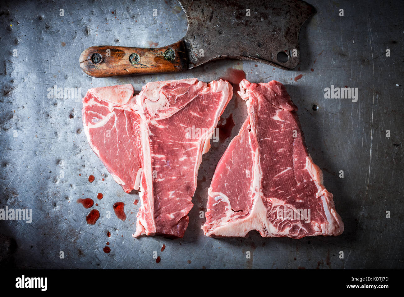 Fresh t-bone steak on old metal table Stock Photo - Alamy
