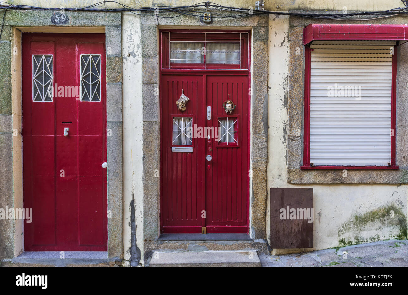 Red doors of a houses on arrow street in Ribeira district in old part ...