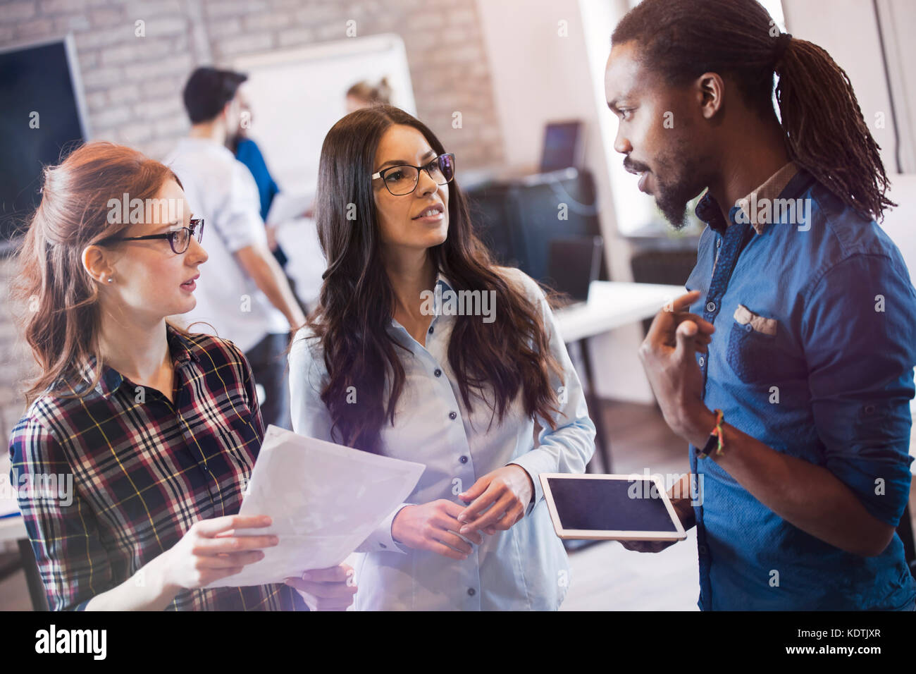 Picture of group of young perspective designers discussing Stock Photo ...
