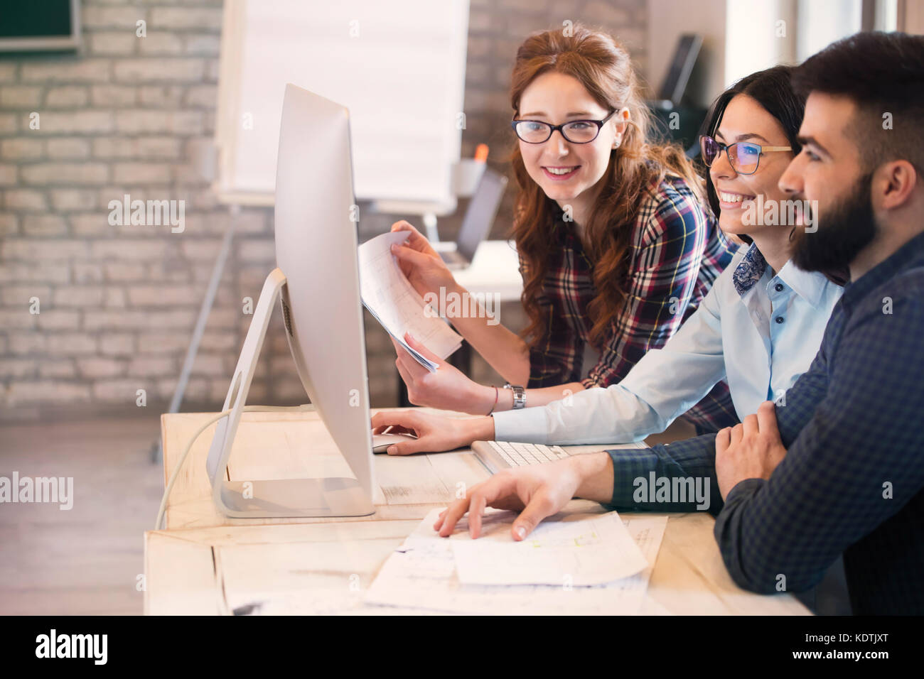 Group of young designers working as team Stock Photo - Alamy
