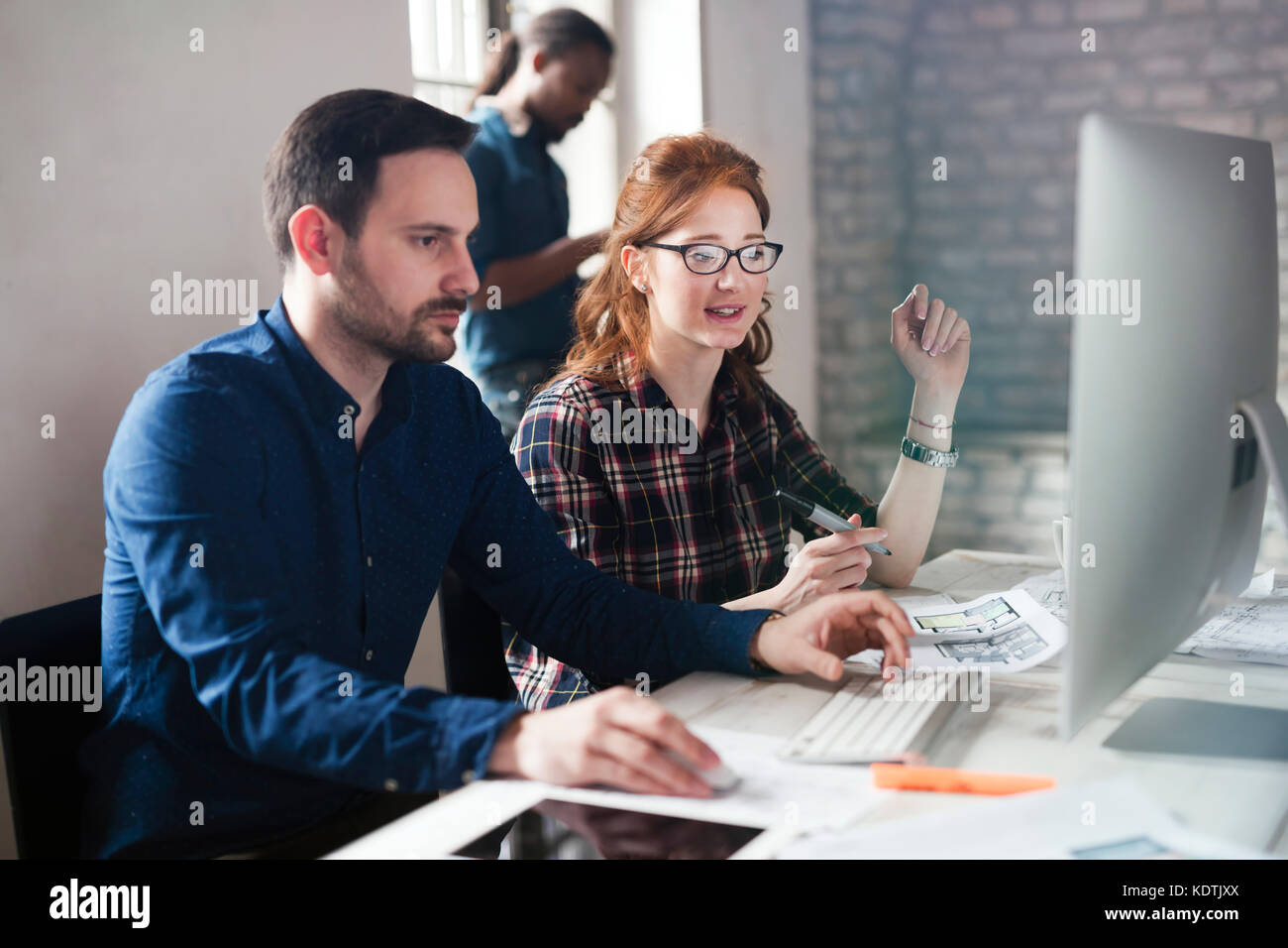 Portrait of young designers working on computer Stock Photo - Alamy