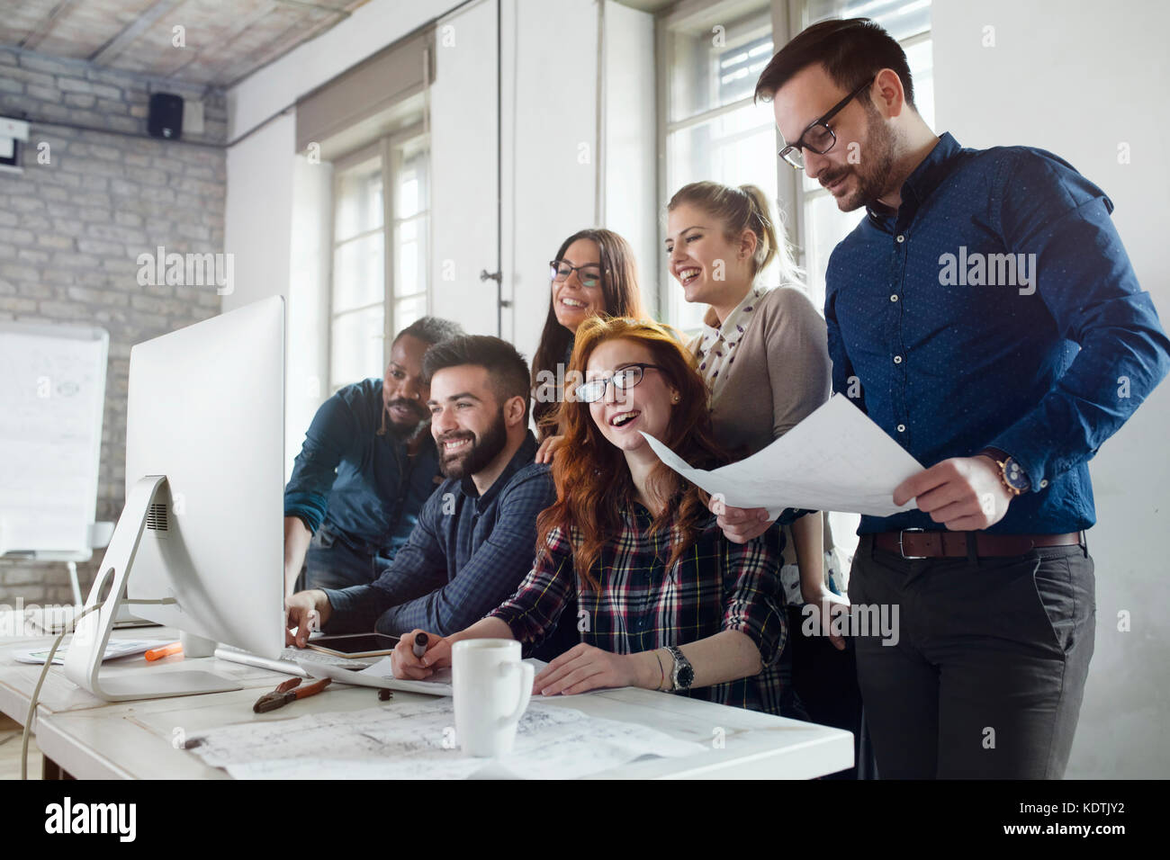 Group of young designers working as team Stock Photo - Alamy