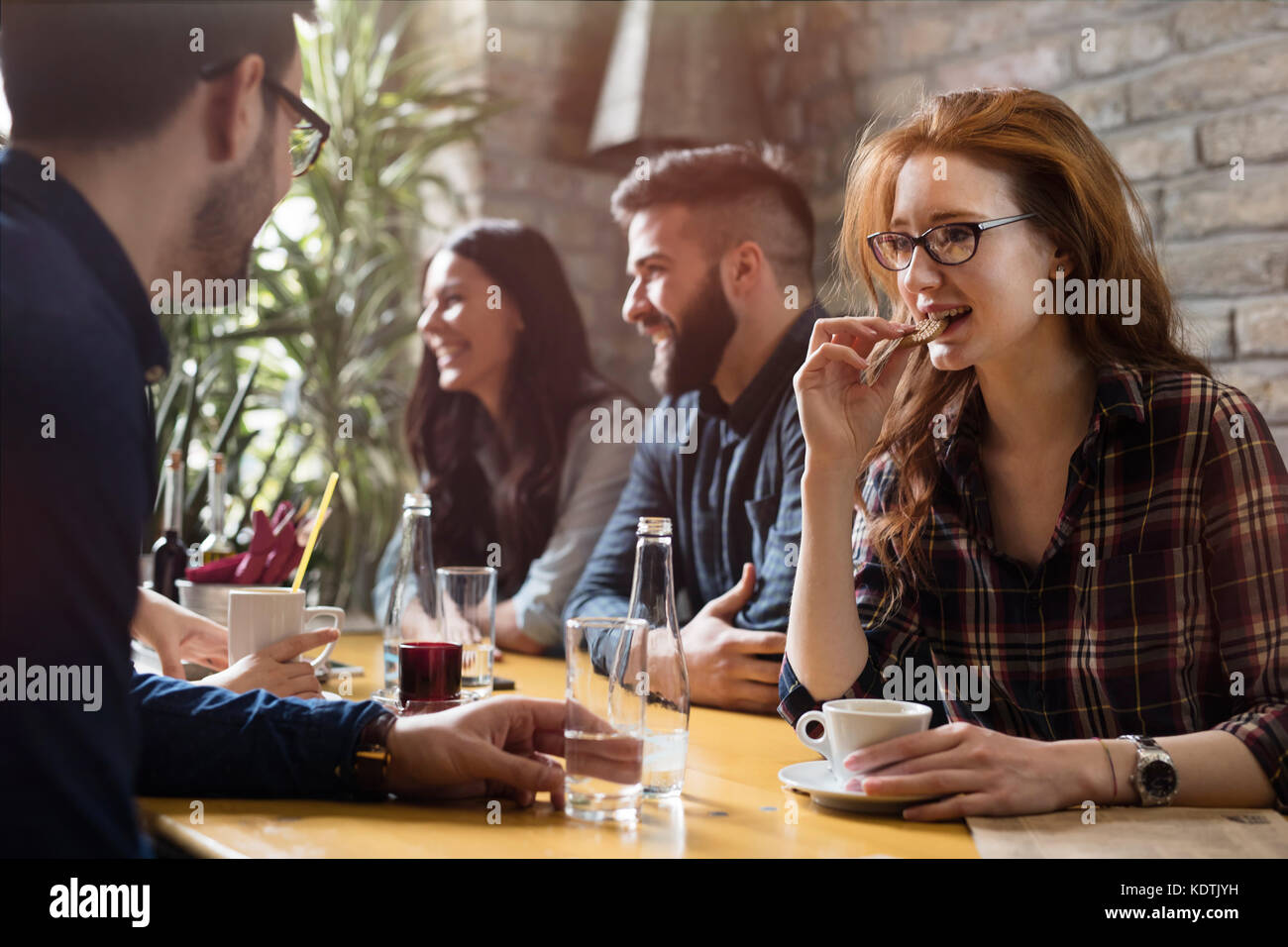 Happy colleagues from work socializing in restaurant Stock Photo - Alamy
