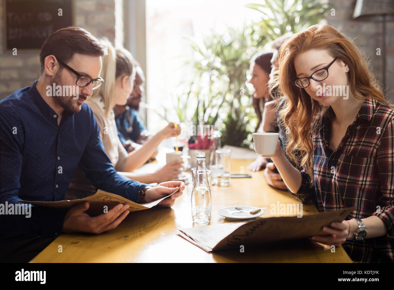 Happy colleagues from work socializing in restaurant Stock Photo - Alamy