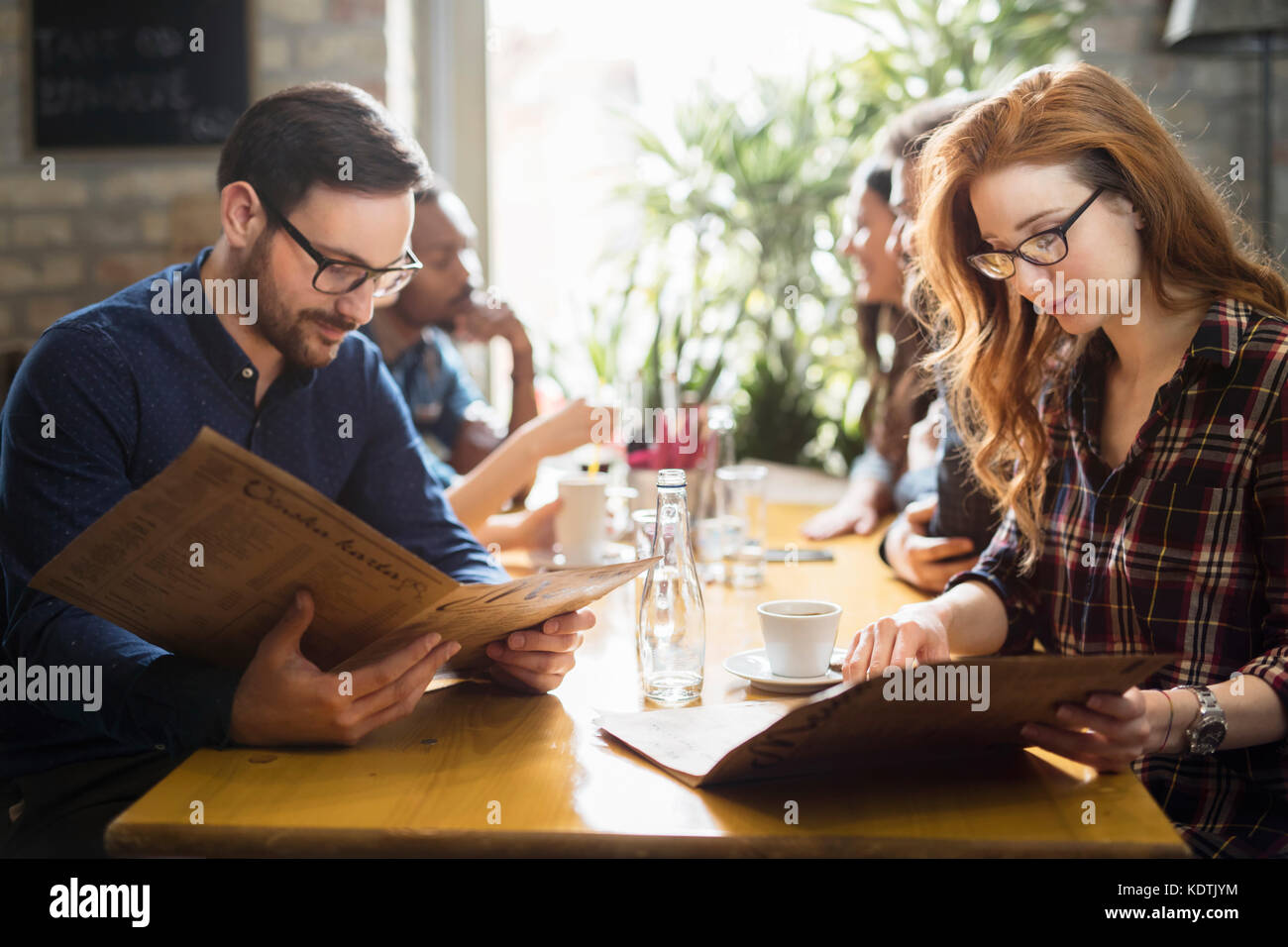 Happy colleagues from work socializing in restaurant Stock Photo - Alamy