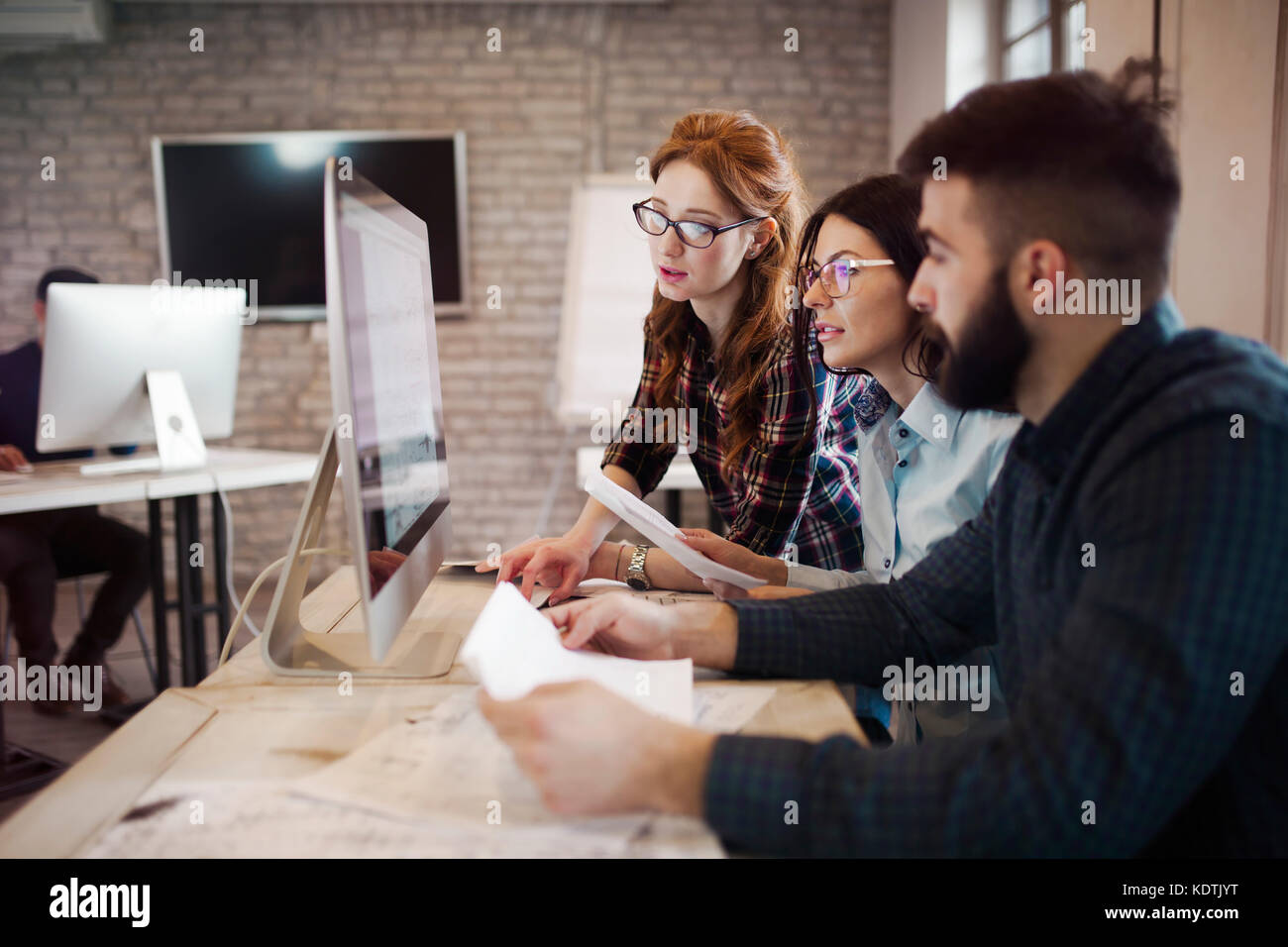 Group of young designers working as team Stock Photo - Alamy