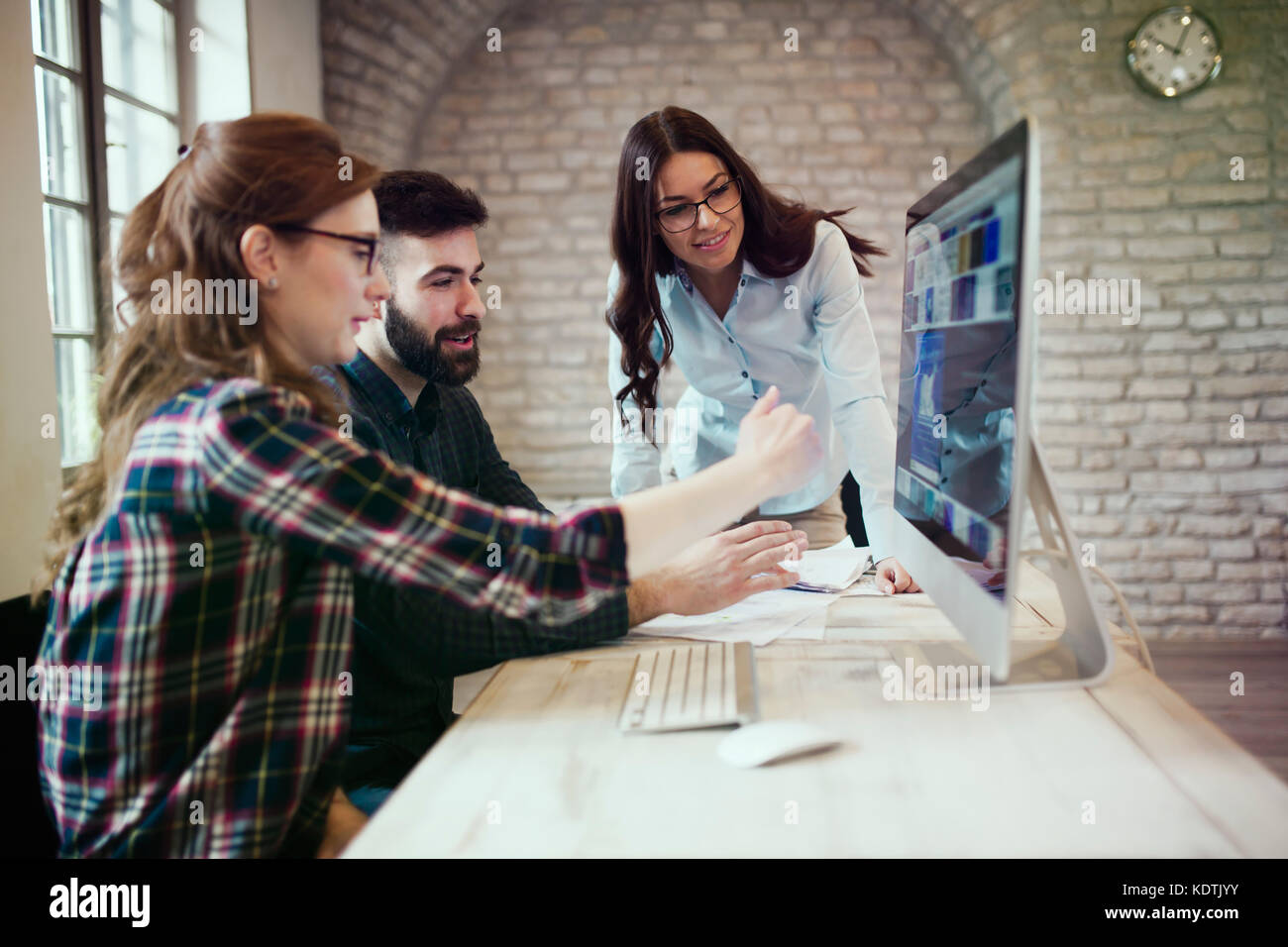 Group of young designers working as team Stock Photo - Alamy