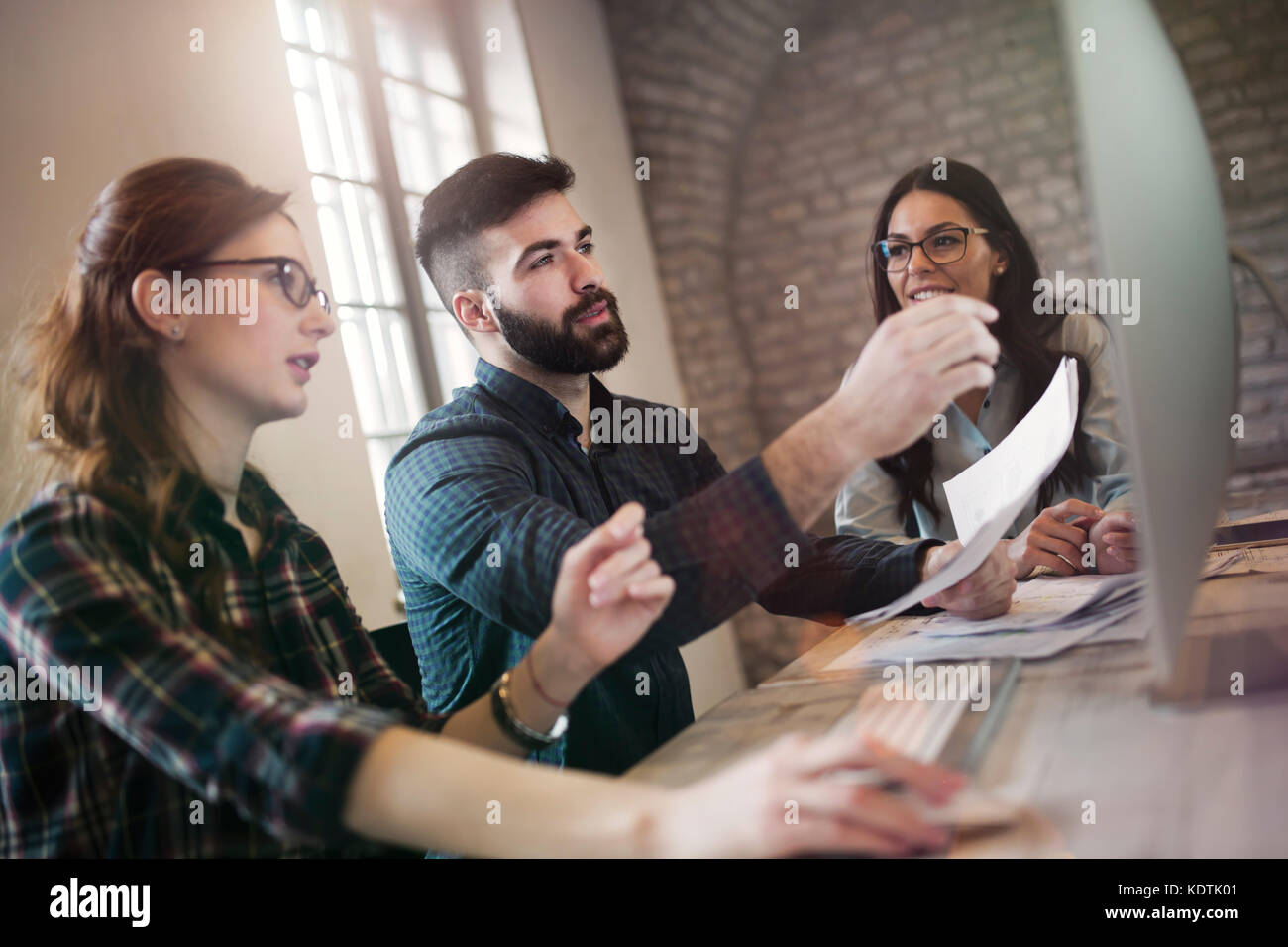 Group of young designers working as team Stock Photo - Alamy