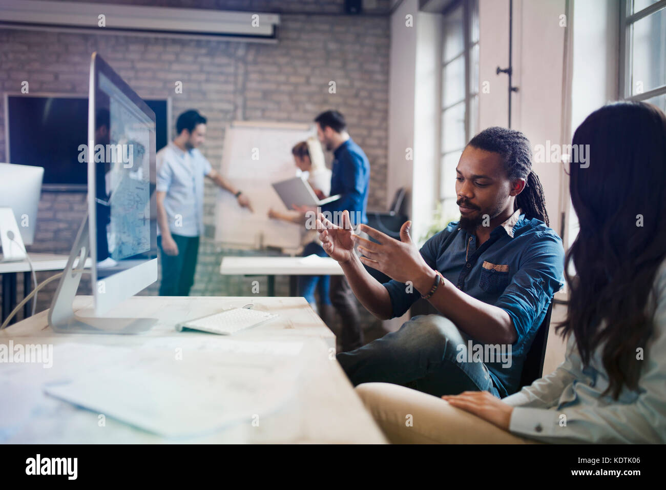 Portrait of young designers working on computer Stock Photo - Alamy