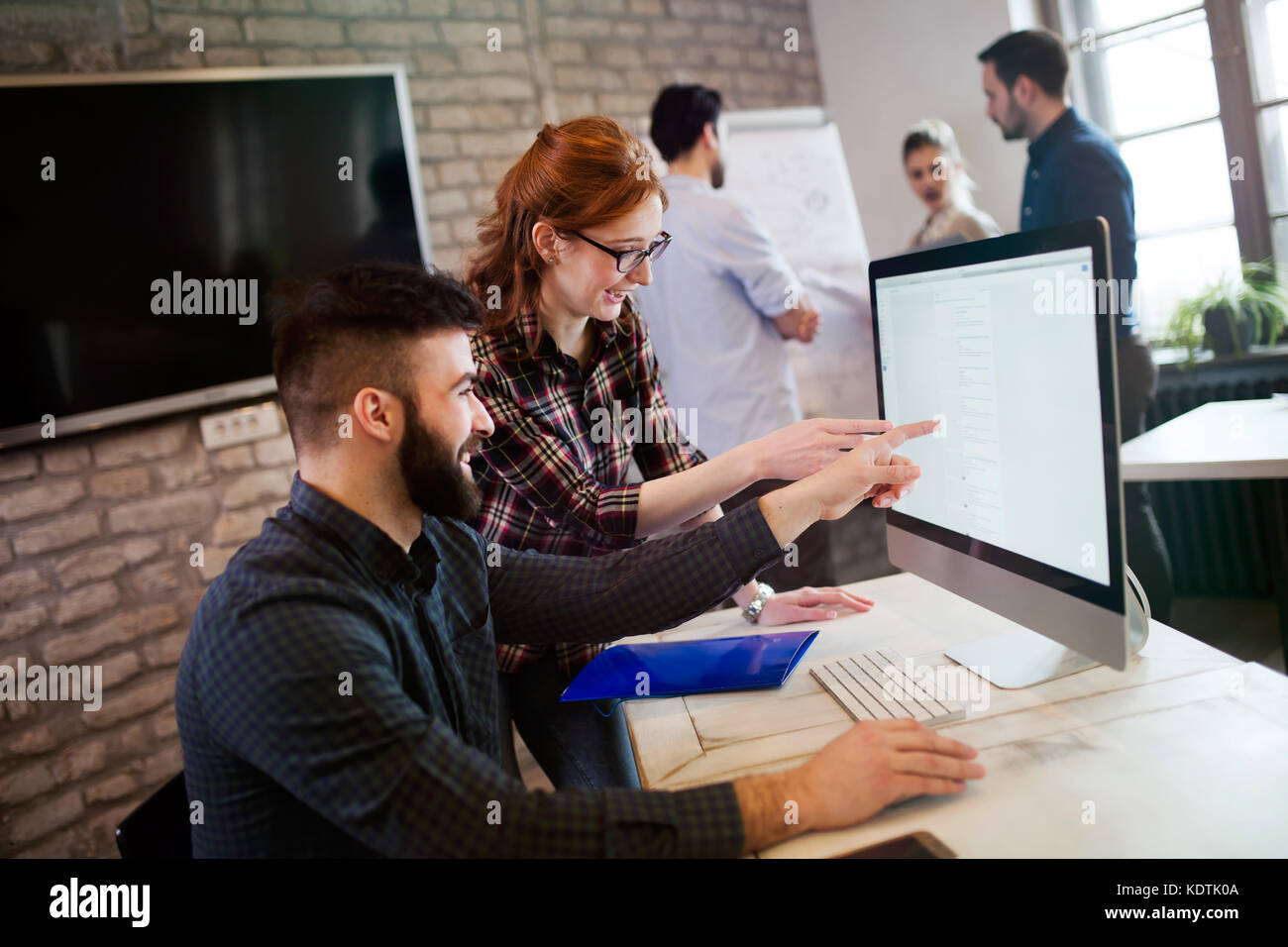 Portrait of young designers working on computer Stock Photo - Alamy