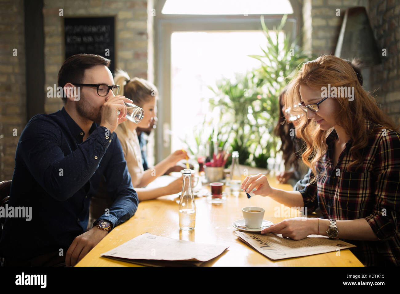 Happy colleagues from work socializing in restaurant Stock Photo - Alamy