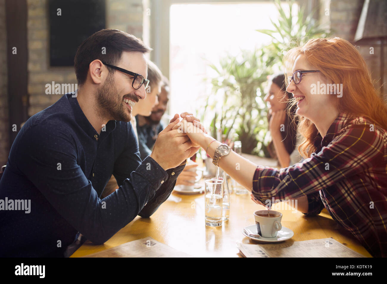 Handsome man flirting with cute woman in restaurant Stock Photo - Alamy