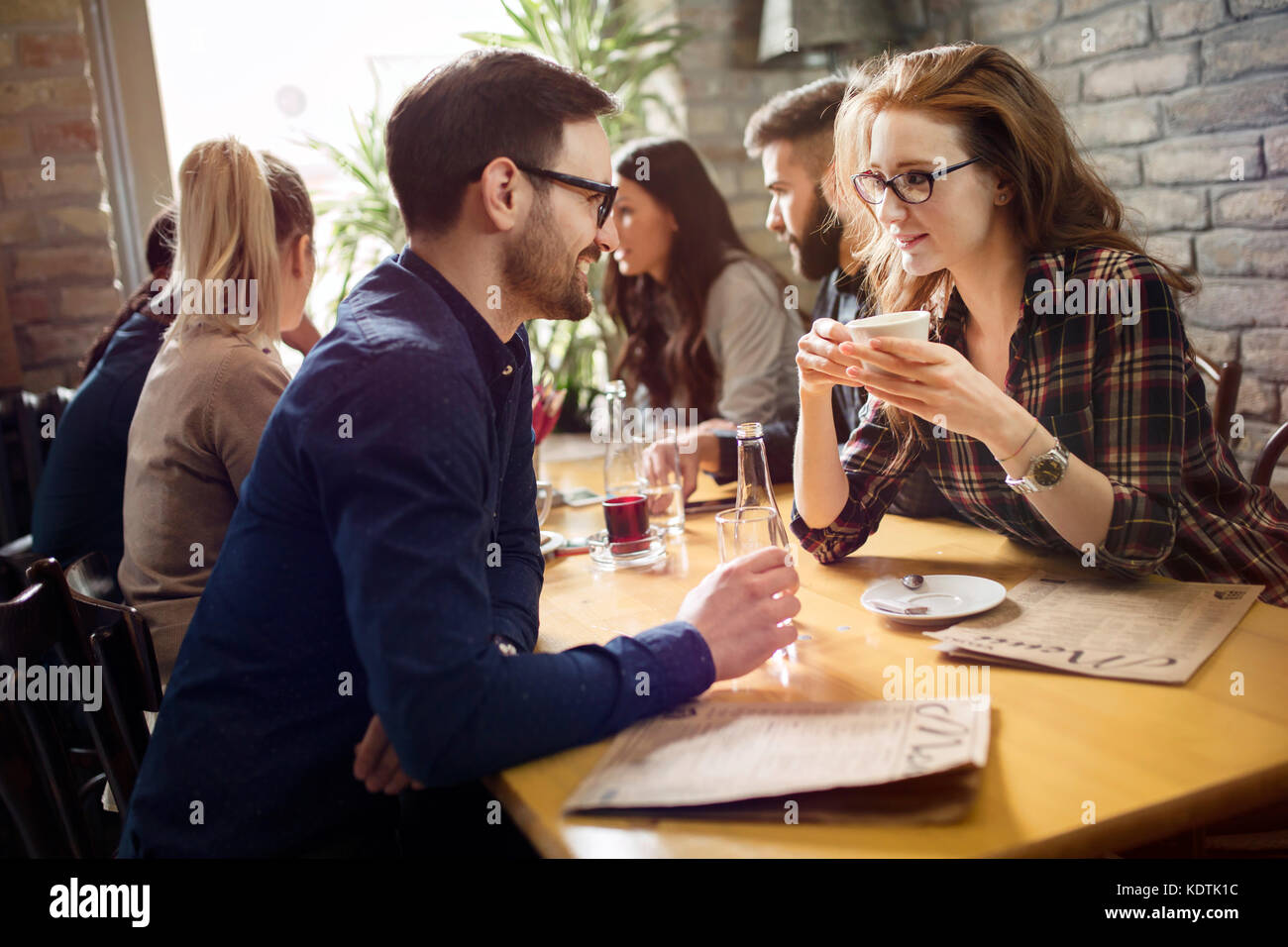 Handsome man flirting with cute woman in restaurant Stock Photo - Alamy