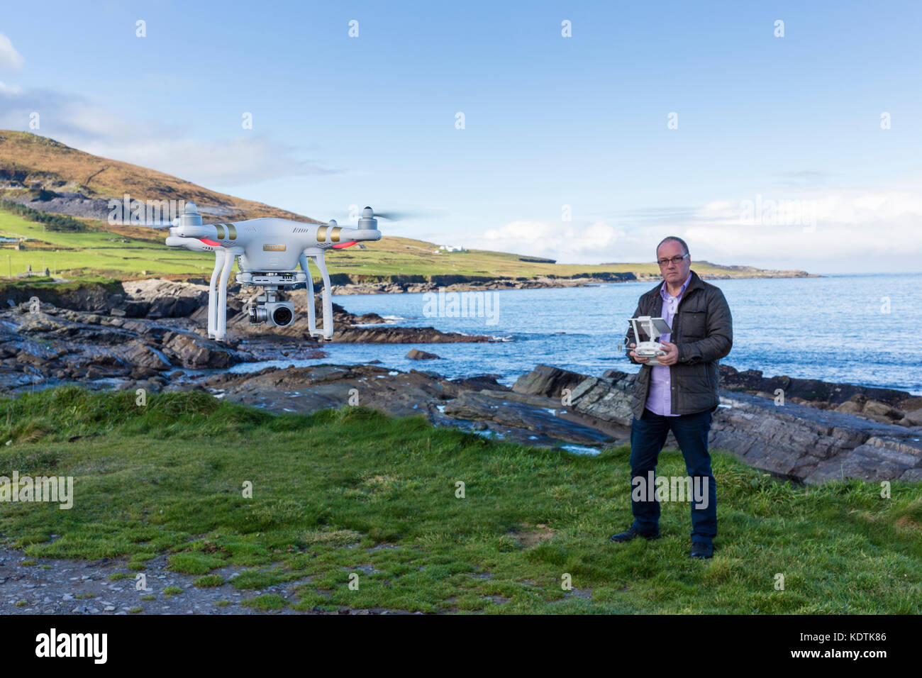 Older man flying drone with a camera Stock Photo - Alamy