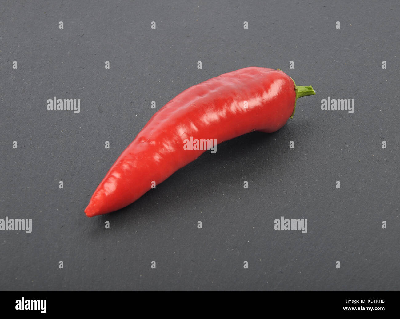 Red ball pepper on slate Stock Photo - Alamy